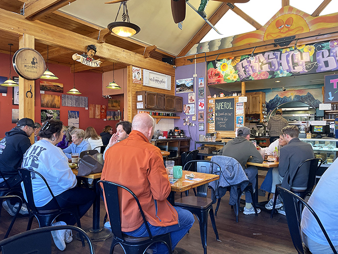 Inside, wooden beams and colorful walls create that perfect "mountain cozy" vibe where strangers become friends over coffee and carbs.