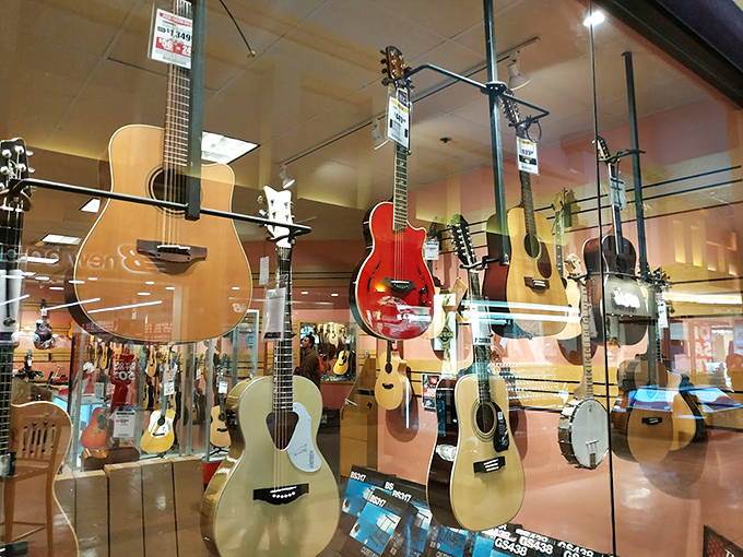 A symphony of strings awaits at Sam Ash Music, where guitars hang like ripe fruit ready to be plucked by the next Eric Clapton.