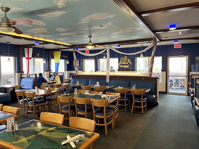 Dining under clouds without getting wet—the whimsical ceiling and nautical flags create an atmosphere that's pure New England charm.