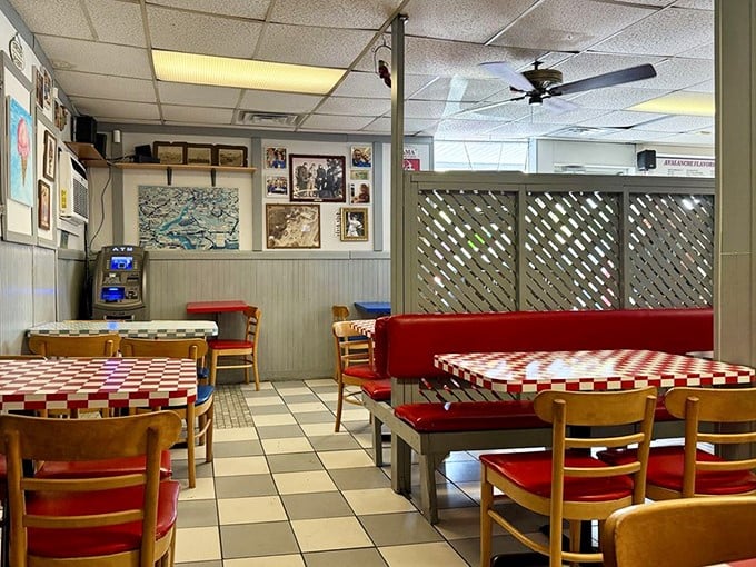Red checkered tables and wooden chairs create a time capsule of Americana where conversations flow as freely as the ice cream. Norman Rockwell would feel right at home.
