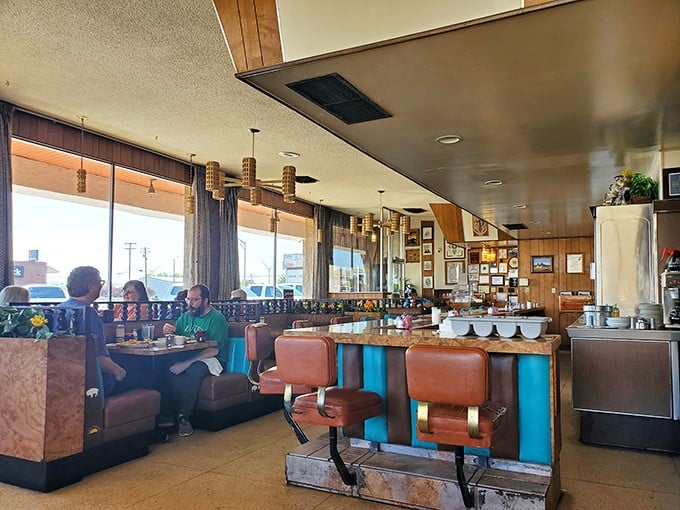 Classic diner vibes with turquoise and orange accents&mdash;where the counter seats are prime real estate for solo diners and the booths hold decades of happy meal memories.
