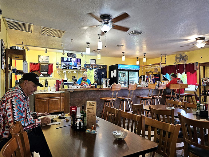 Inside, ceiling fans lazily spin above wooden tables where regulars have claimed their spots, creating that perfect diner symphony of clinking plates and conversation.