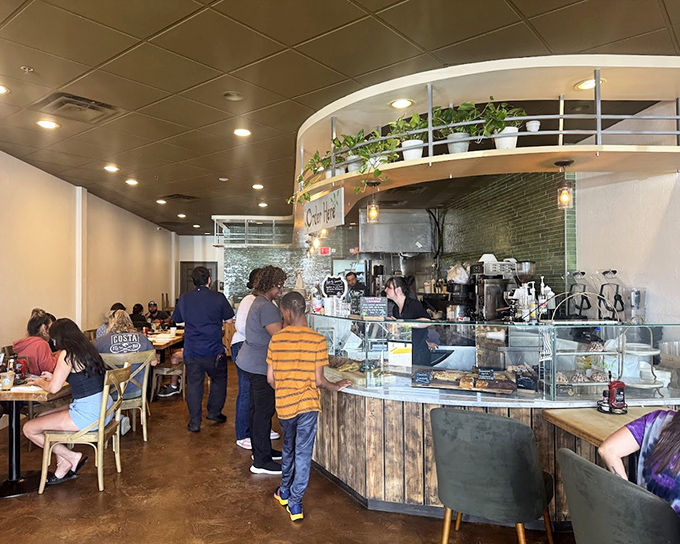 Inside, the curved counter and hanging plants create that perfect "I could stay here all morning" vibe that every great breakfast spot needs.
