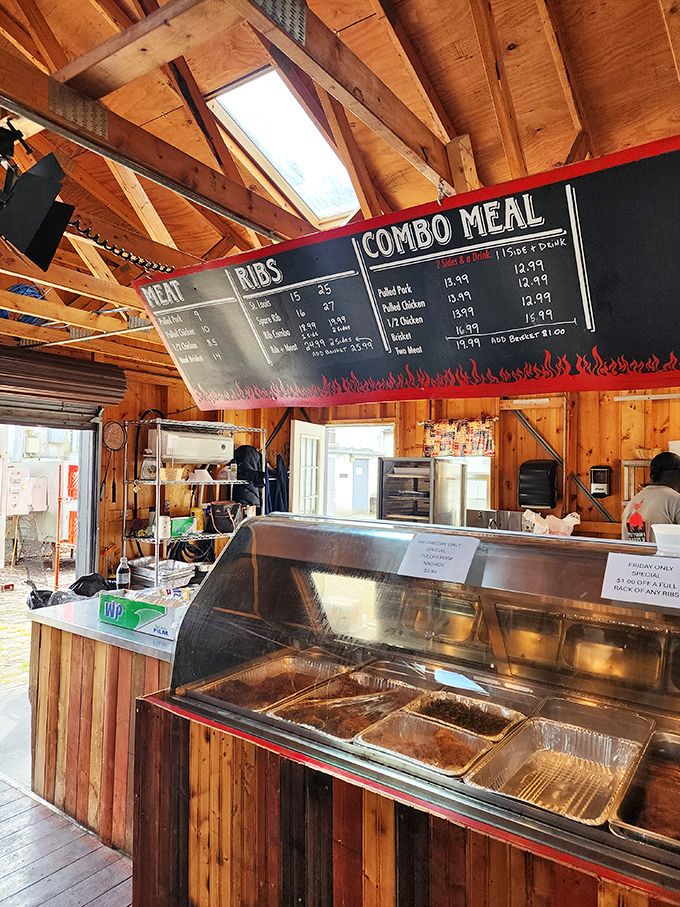 Rustic wooden beams frame a menu that reads like a carnivore's dream. In this temple of smoke, the cathedral ceiling seems designed to let barbecue prayers ascend heavenward.