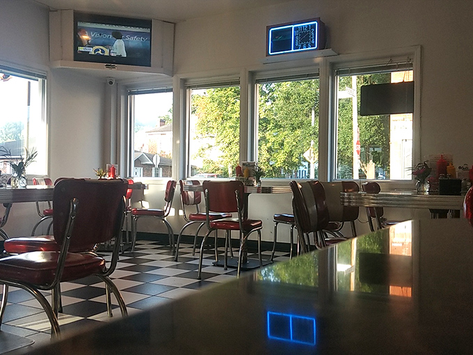 Sunlight streams through large windows, illuminating the checkerboard floor and chrome-trimmed chairs where countless conversations and comfort meals have unfolded.