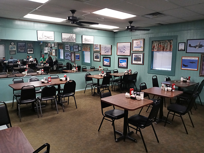 Aviation memorabilia adorns mint-green walls, creating a dining room that feels like a cozy museum where the main exhibit is comfort food served with Texas-sized hospitality.