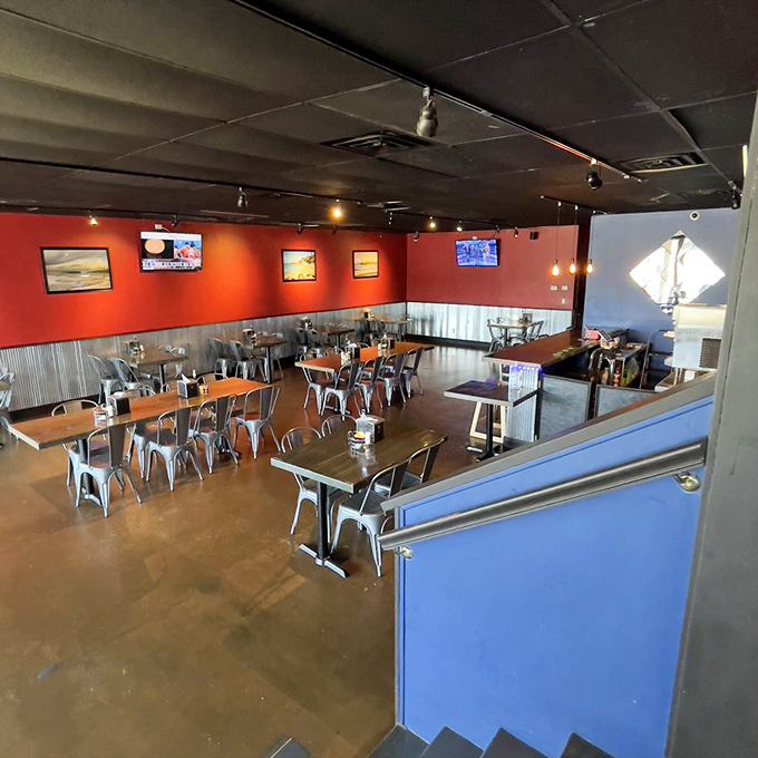 Industrial-chic meets seafood sanctuary in this modern dining space. The vibrant red walls aren't just decorative&mdash;they're foreshadowing the heat of that Cajun butter to come. 