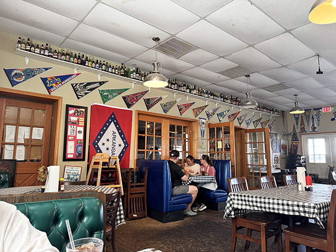 College pennants and blue booths create that perfect "come as you are" vibe where conversations flow as freely as the sweet tea.