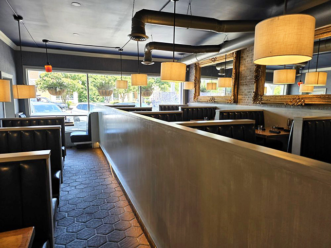 Warm pendant lighting and comfortable booths create that perfect "coastal comfortable" atmosphere where both flip-flops and formal wear feel equally at home.