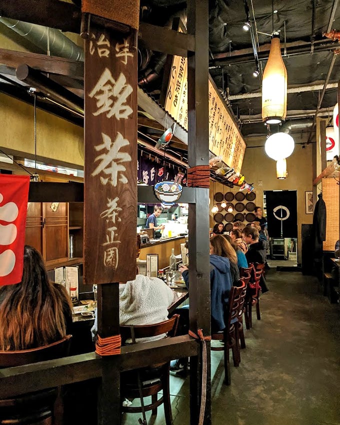 Step inside and you're transported to a Japanese izakaya, where wooden beams and traditional banners create an atmosphere that's worth the trip alone.