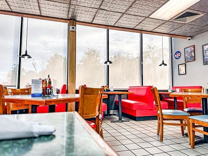 Red vinyl booths and wooden chairs create that perfect diner atmosphere where conversations flow as freely as the coffee refills.