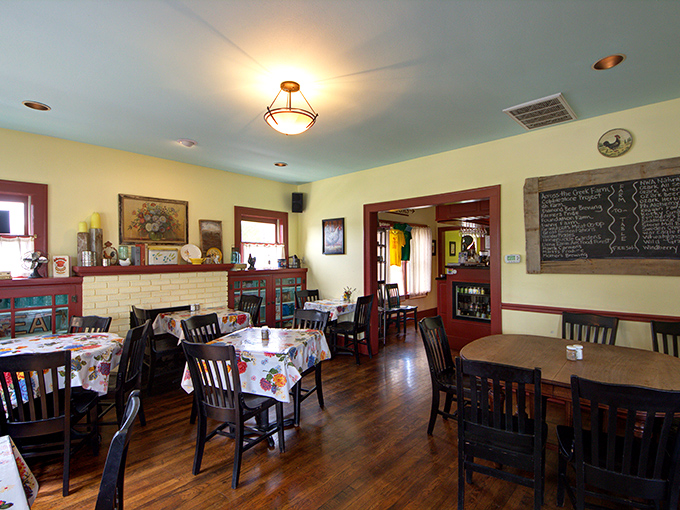 Warm wood floors, colorful tablecloths, and natural light create the kind of cozy atmosphere that makes you want to linger over that third cup of coffee.