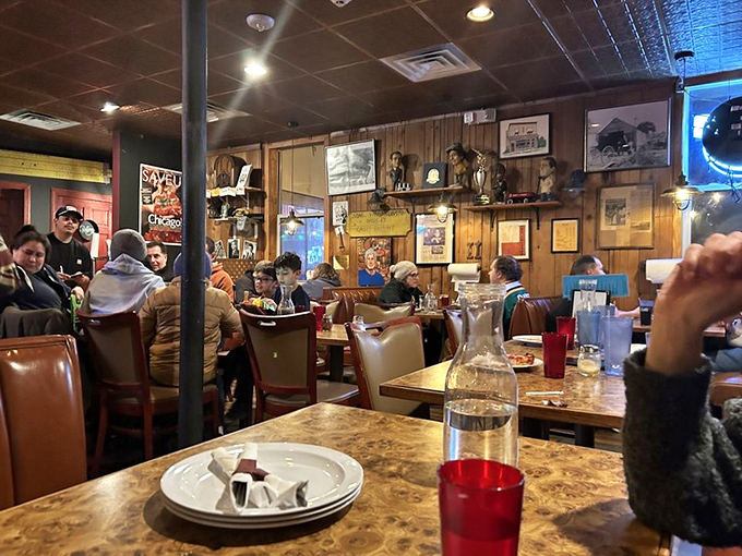 Wood-paneled walls adorned with memorabilia create the perfect time capsule atmosphere, where conversations between strangers become inevitable over pizza.