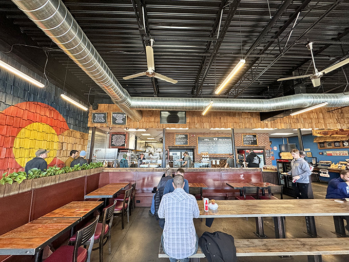 Inside, the Colorado flag mural meets exposed ductwork in a space that says, "We're here for the meat, not the marble countertops."