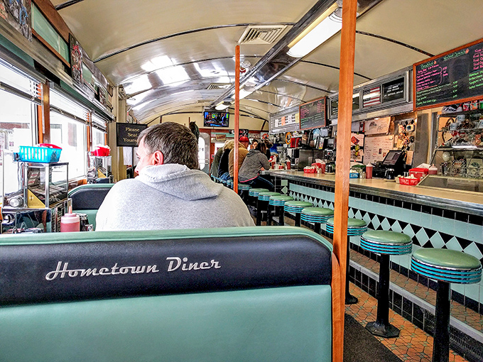 Inside, teal vinyl stools and the embossed booth backs create that perfect diner atmosphere where conversations flow as freely as the coffee.