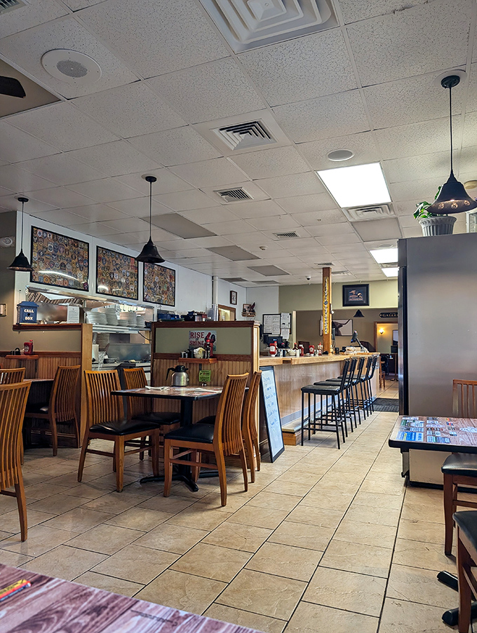 Classic diner ambiance at its finest&mdash;wooden tables, counter seating, and pendant lighting create that "come as you are" atmosphere where comfort trumps pretension.