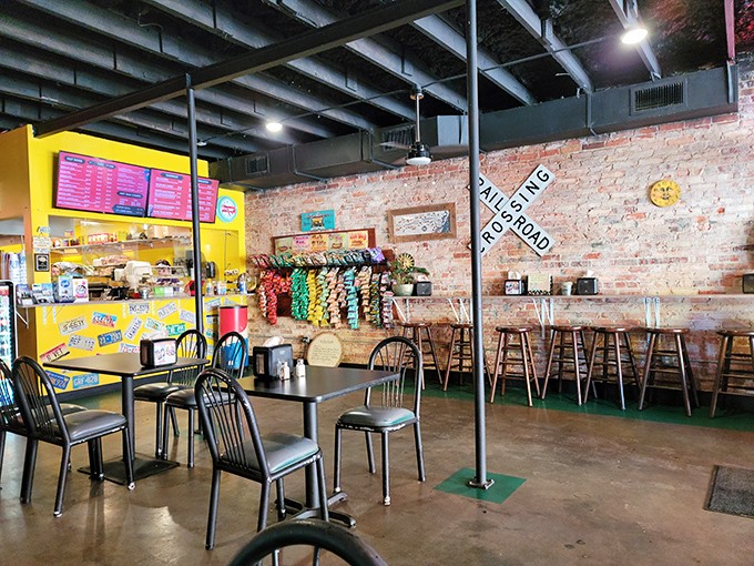 Exposed brick walls, railroad crossing signs, and chip racks create that perfect "I've discovered something authentic" atmosphere that makes food taste even better.