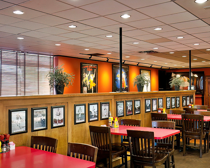 Warm wood paneling, vintage photographs, and those signature red tables create the perfect backdrop for the food memories you're about to make.
