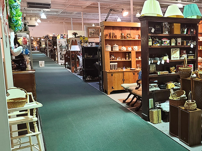 Green carpeted aisles lead you through a maze of vendor booths, each one a carefully curated collection of memories and potential treasures.