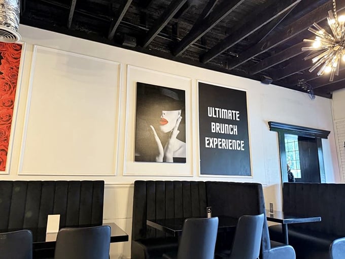 Modern elegance meets brunch comfort with sleek black booths, artistic wall decor, and that statement starburst chandelier that screams "this isn't your average breakfast joint."