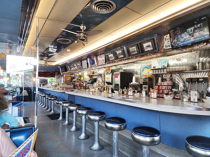 Classic counter seating where strangers become friends and the coffee keeps flowing like conversation at a family reunion.