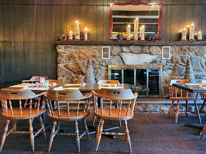 Wooden captain's chairs surround tables facing a magnificent stone fireplace. This isn't just rustic charm&mdash;it's the stage where steak dreams become delicious reality.