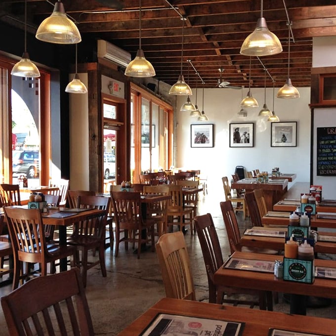 Simple wooden tables, exposed beams, and golden pendant lights create the perfect backdrop for the meat-centric drama about to unfold on your plate.