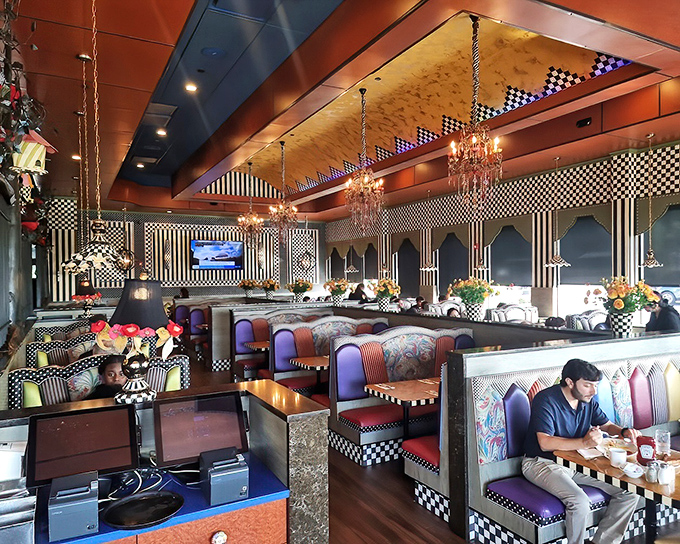 Inside, whimsy reigns supreme with checkered patterns, chandeliers, and colorful booths. It's as if Alice in Wonderland opened a diner after winning the lottery.