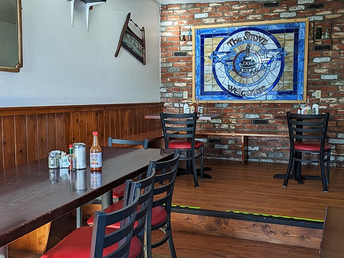 Inside, exposed brick meets wooden wainscoting while a stunning stained glass welcome sign reminds you this isn't some cookie-cutter chain&mdash;this is somewhere that matters.