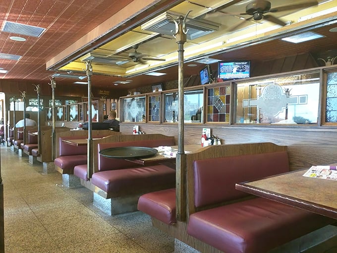 Classic burgundy booths and wood paneling create that timeless diner atmosphere where conversations flow as freely as the coffee. This isn't trendy&mdash;it's timeless.