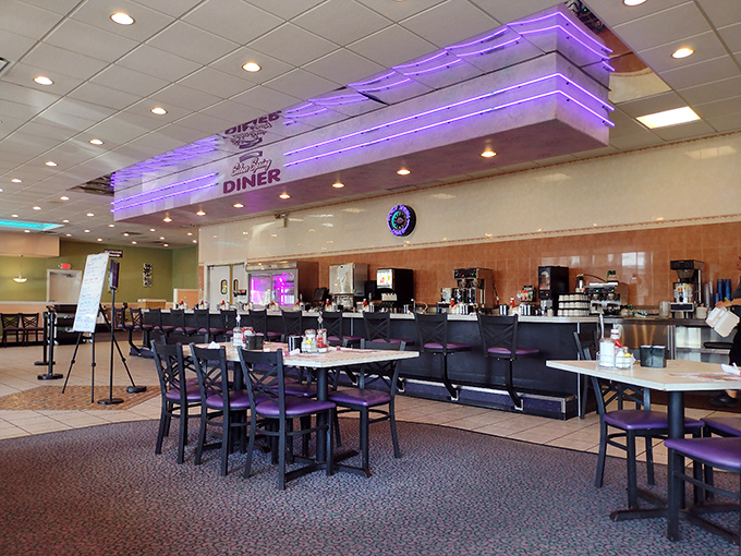 Purple neon accents give the interior a touch of retro-cool ambiance. Like walking into a diner where the 1950s and 2020s decided to become friends.
