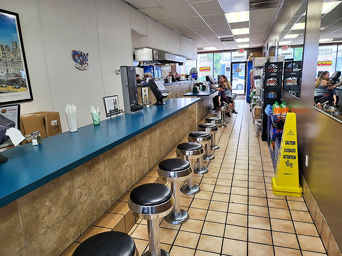 Classic counter seating where culinary magic happens. Those stools have witnessed more food epiphanies than a cooking show marathon.