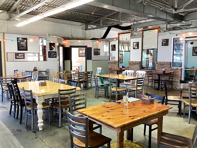 Mismatched tables, string lights, and exposed brick create that perfect "discovered treasure" vibe. Industrial meets cozy in this breakfast lover's playground.