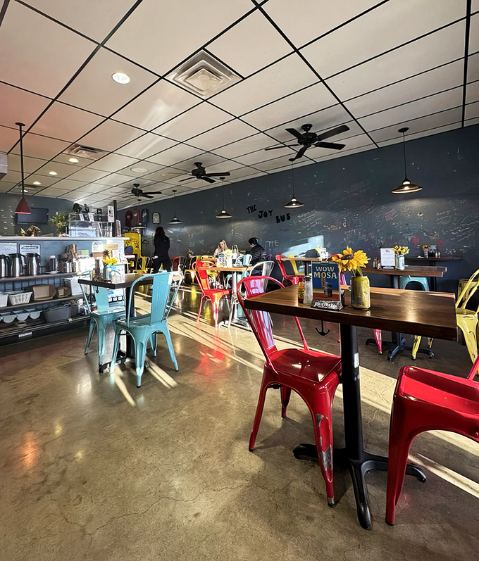 Colorful metal chairs pop against concrete floors, creating a space that feels both modern and welcoming&mdash;like your coolest friend's kitchen.