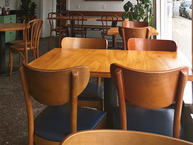 Warm wooden chairs invite lingering conversations over coffee and biscuits. This isn't just eating&mdash;it's therapy with carbs.