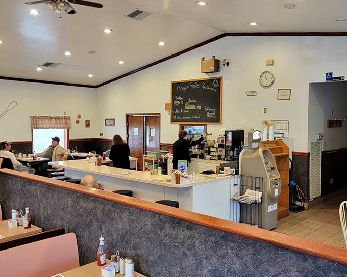 The classic diner counter setup at Mary's&mdash;where regulars perch like birds on a wire, watching breakfast magic unfold.