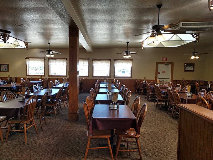 Simple wooden chairs and tables create the perfect canvas for culinary masterpieces. No pretension, just space for serious eating.