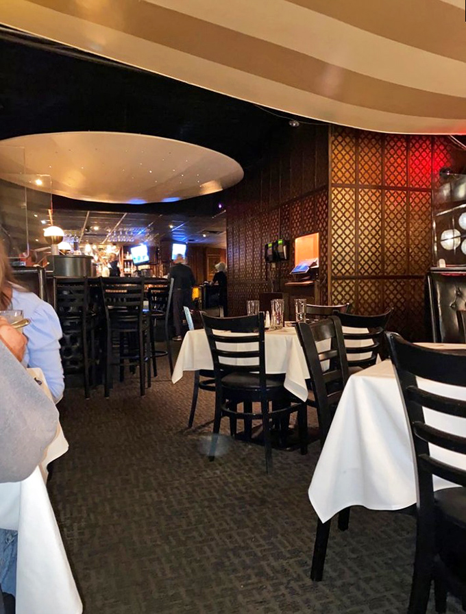 Latticed dividers and white tablecloths create intimate dining spaces where memories are made and steaks are savored.