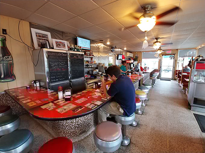 The quintessential American diner counter where strangers become friends over coffee, complete with spinning stools and a leopard-print trim that's delightfully retro.