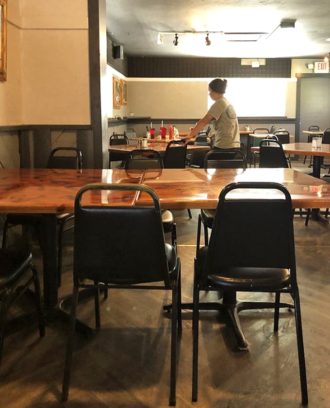 Simple wooden tables and black chairs create that rare, honest dining atmosphere where the food—not the furniture—does all the talking.