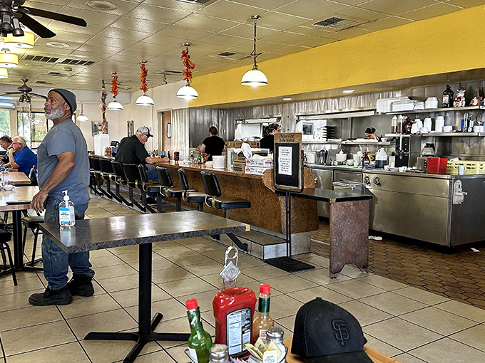 Classic diner counter seating where locals gather for morning coffee and conversation, proving the best restaurants prioritize community over Instagram-worthy aesthetics.