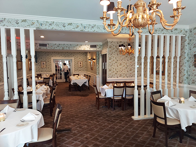 Those white columns and chandeliers create dining room magic that makes every meal feel like a special occasion worth celebrating.