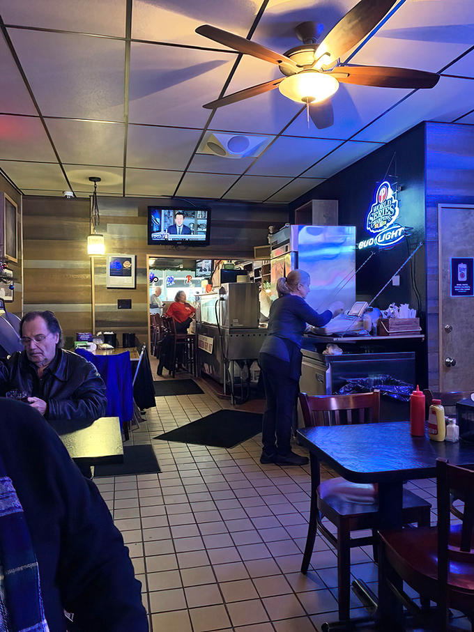 Inside, ceiling fans spin lazily above a no-nonsense interior where the only decoration needed is the aroma of slow-roasted beef.