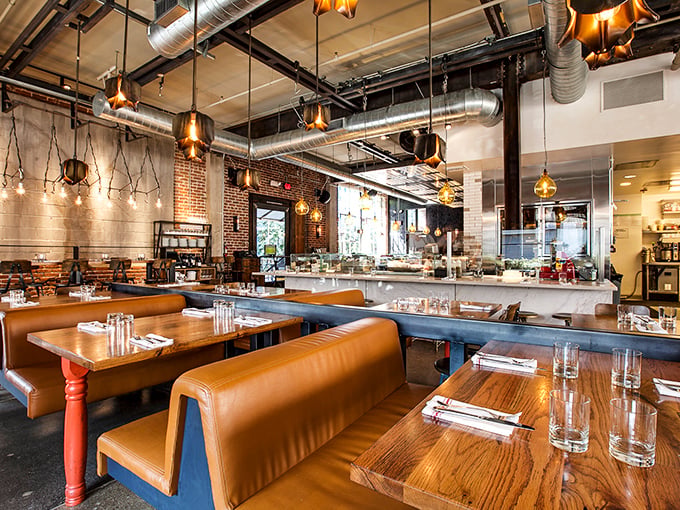 Industrial chic meets Italian warmth where exposed ducts and copper lighting hover above leather banquettes, creating LA's perfect marriage of grit and glamour.