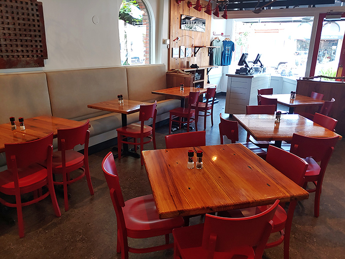 Simple red chairs and wooden tables create the perfect stage where seafood takes the spotlight. No distractions, just deliciousness awaiting.