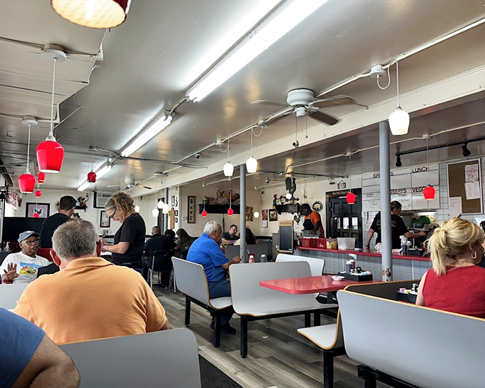 Inside Ruth's, where red pendant lights hang like culinary exclamation points above tables of satisfied diners. This is Augusta's morning headquarters.
