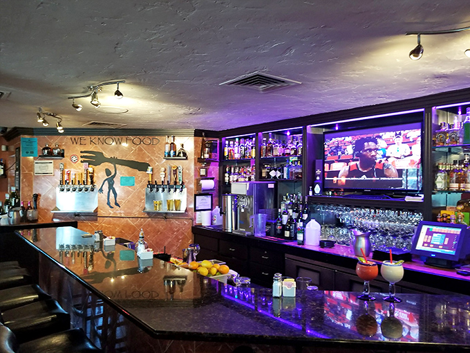 The purple-lit bar creates an ambiance that's sophisticated without being stuffy&mdash;perfect for serious eating and casual conversation.