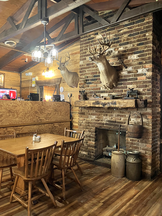 Rustic charm meets hunting lodge aesthetics where exposed brick, mounted trophies, and warm wood create an inviting Tennessee atmosphere.