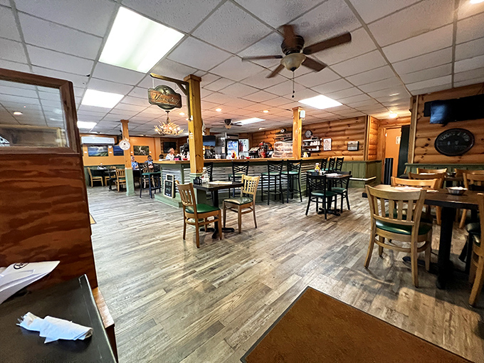 Step inside to a warm cabin-like atmosphere where wooden beams, comfortable seating, and mountain charm create the perfect backdrop for serious comfort food indulgence.