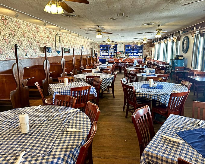 Blue gingham tablecloths and wood paneling create the time-travel experience we all crave. Somewhere between 1975 and yesterday, comfort found its permanent home.
